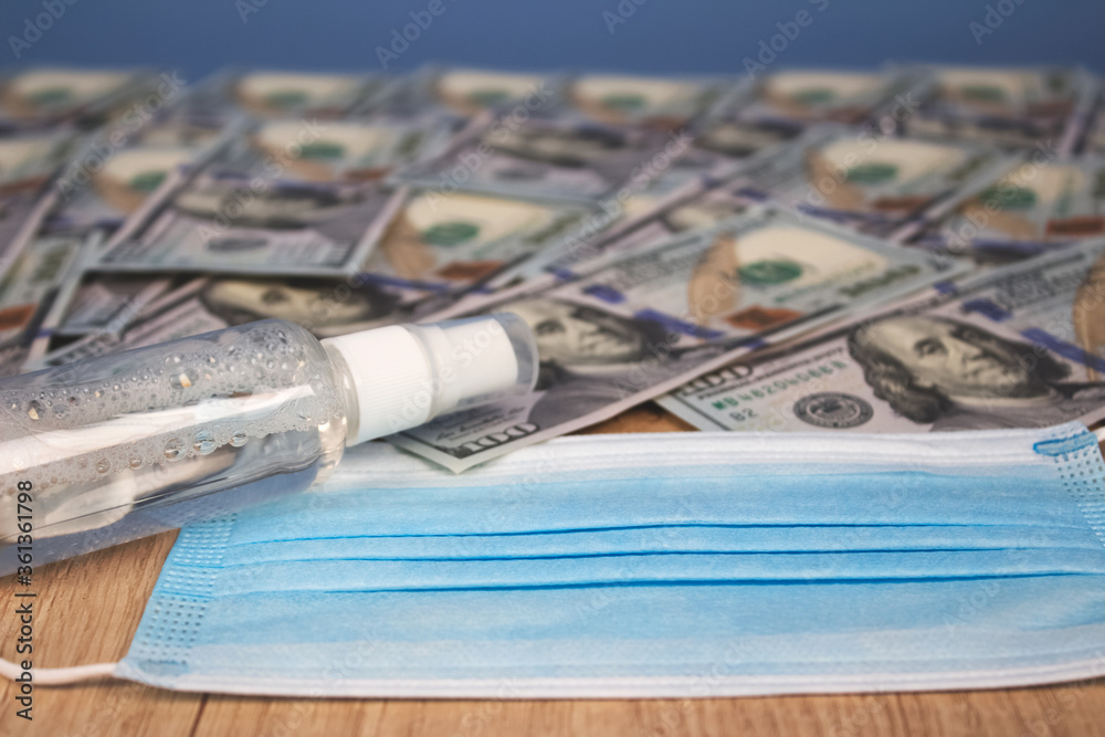 Disposable face mask and antiseptic spray or sanitizer with paper money ...