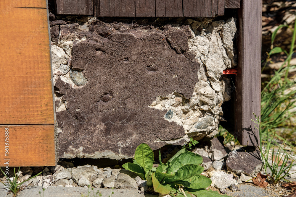 A concrete foundation pillar made of concrete falls apart and small ...