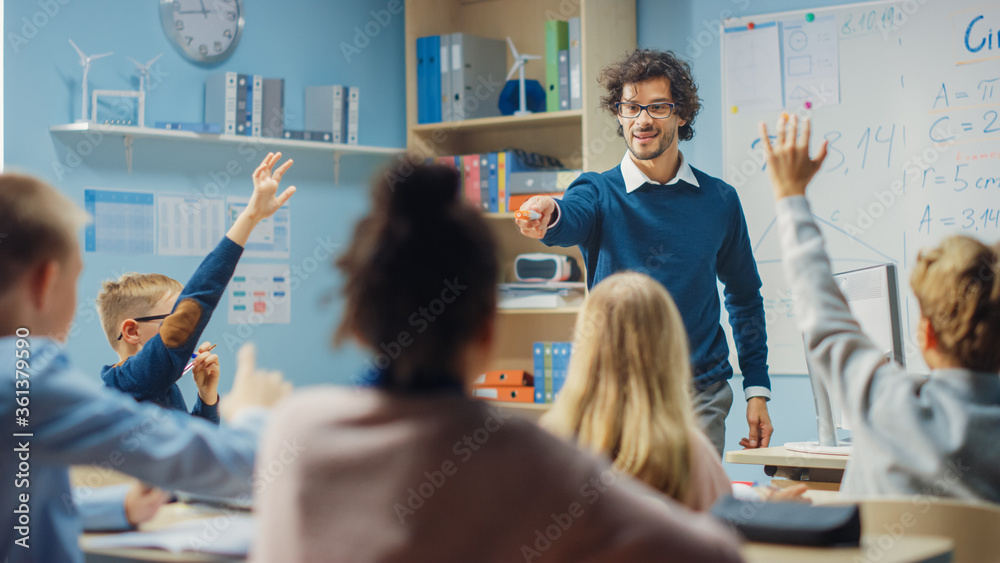 Teacher Explains Lesson to a Diverse Classroom of Bright Children. In ...