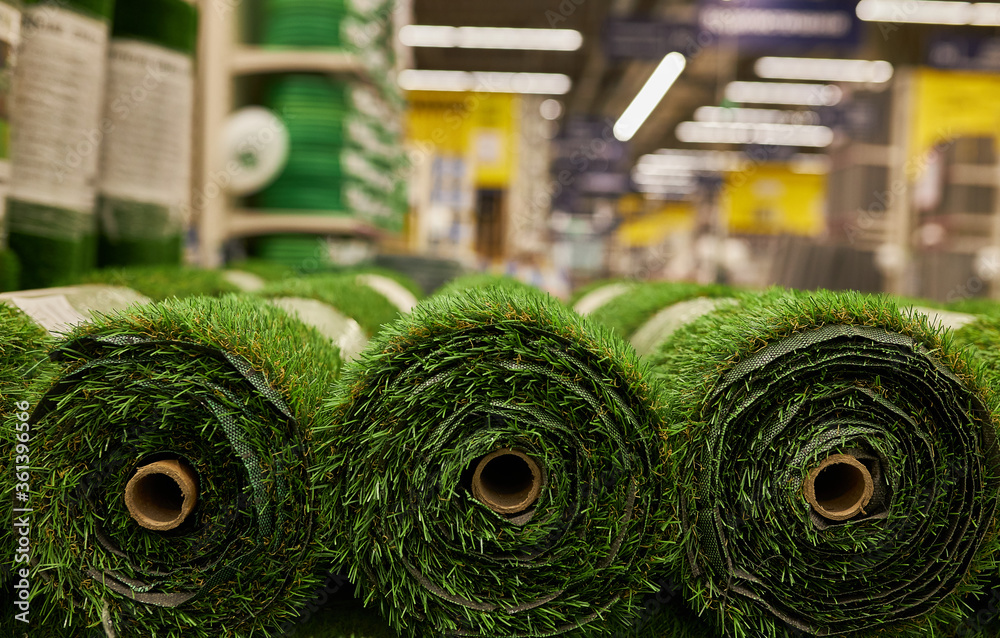 green artificial grass in rolls, close up. Rolls artificial grass in ...