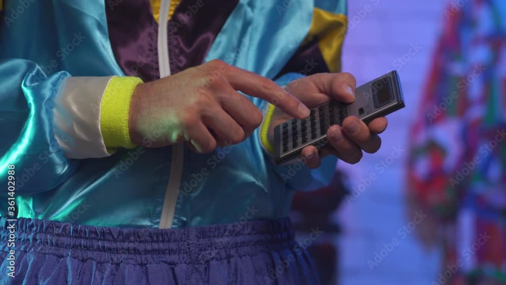 Using a vintage old calculator to calculate. 90s 80s retro scene. Stock ...