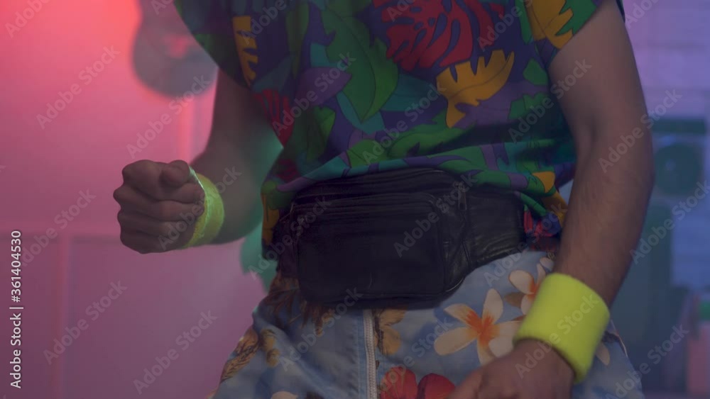 Medium shot of a dancer in the 80s 90s moving his body and having fun ...