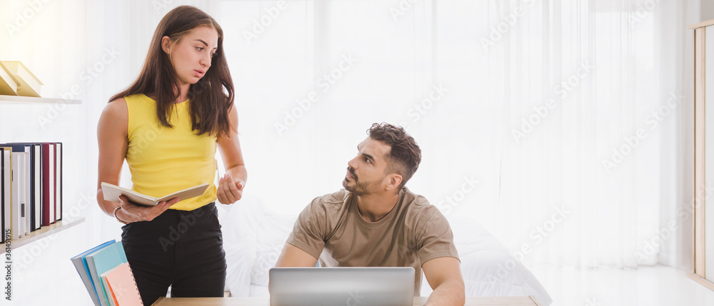 Caucasian couple work from home on social media use laptop notebook computer in bedroom on desk ...