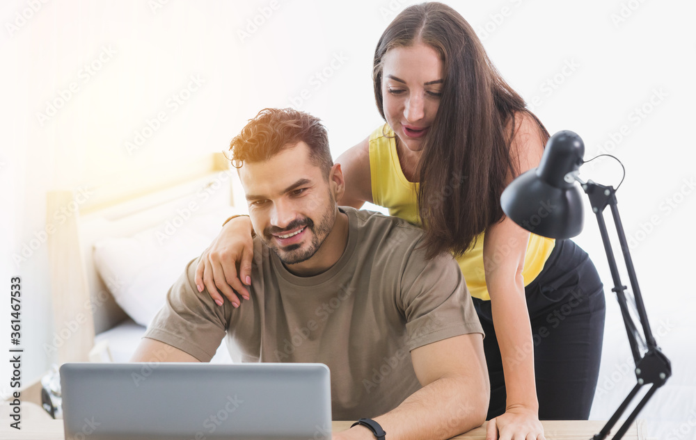 Caucasian couple work from home on social media using laptop notebook ...