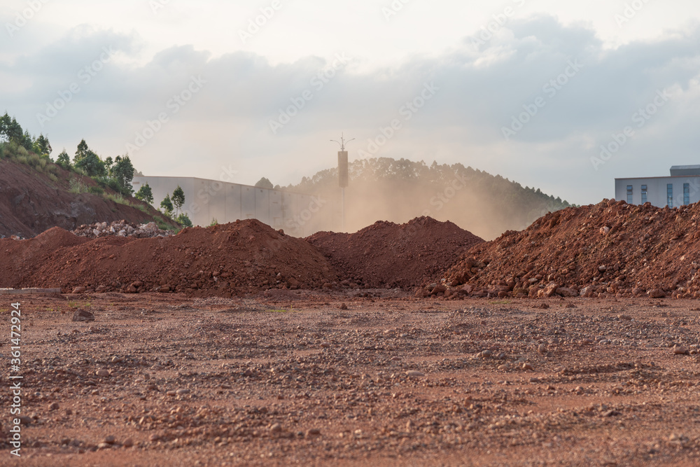 Dirt piles and dust from the wind at the construction site Stock Photo ...