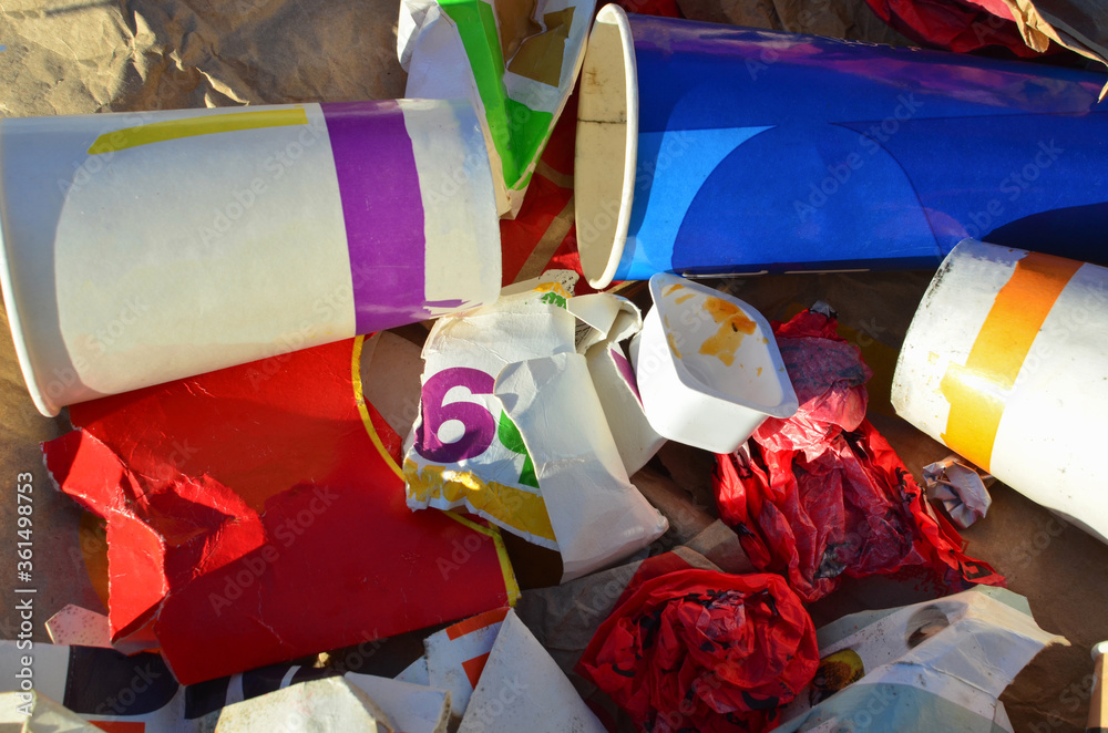 People throw coffee cups on snow. A pile of abandoned garbage on the ...