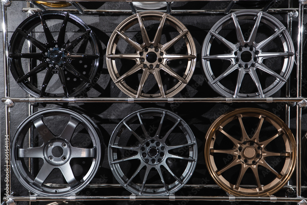 wall of alloy wheels in the store. Auto repair shop background. Auto ...