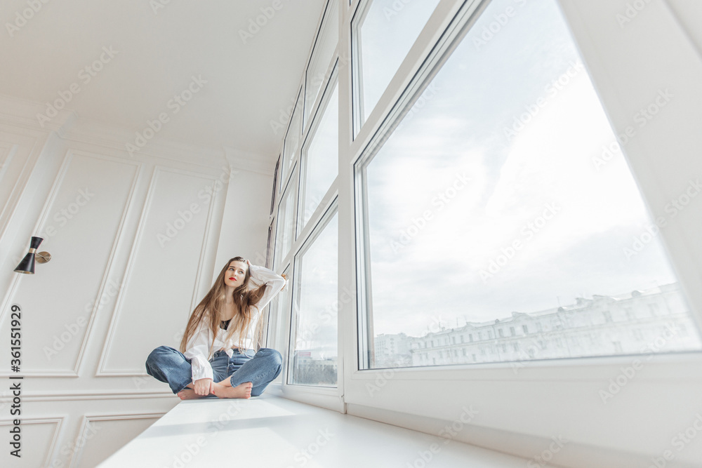beautiful girl sitting on the window and smiling Stock Photo | Adobe Stock
