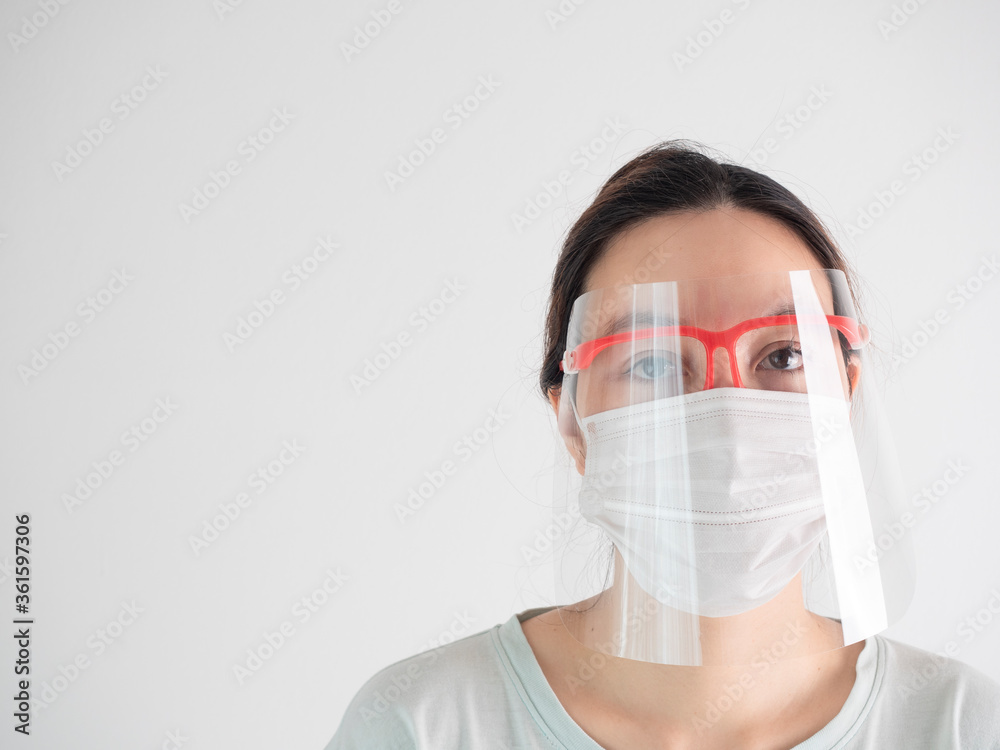 Portrait of Asian woman wearing red face shield glasses and medical ...