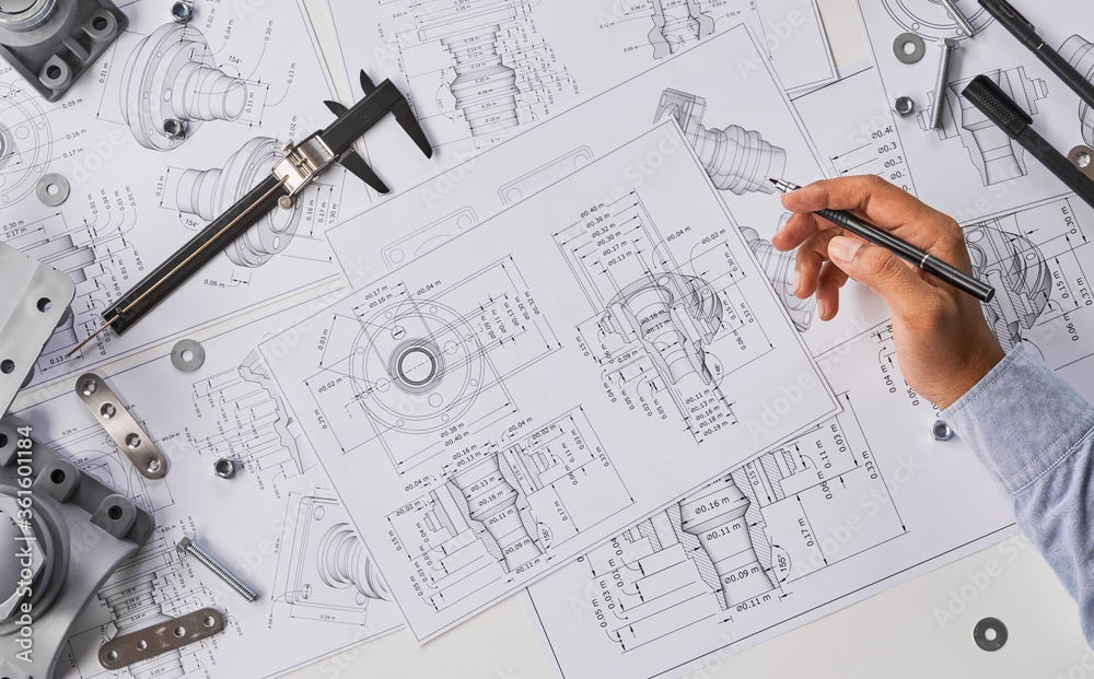 Engineer technician designing drawings mechanical parts engineering ...