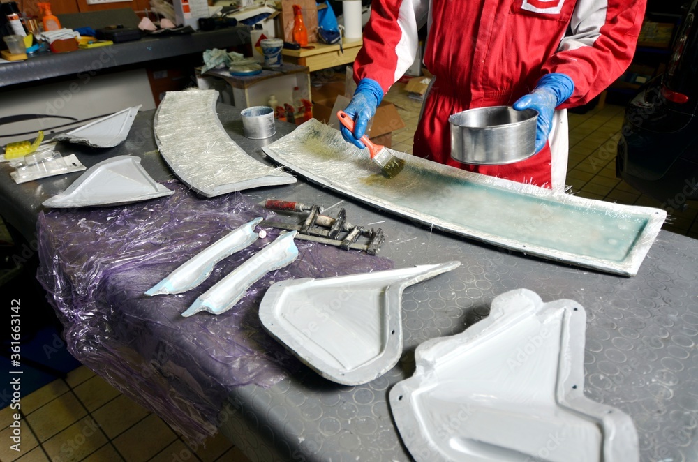 Installation of fiberglass: worker manually realizes a component in ...