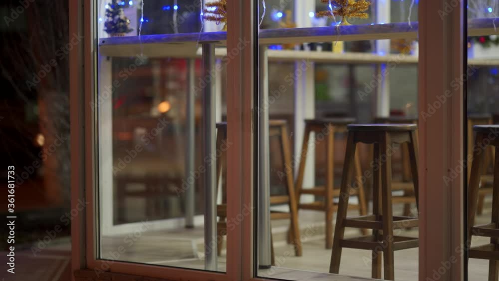 Coffee shop window display with festive lighting at dusk, window of ...