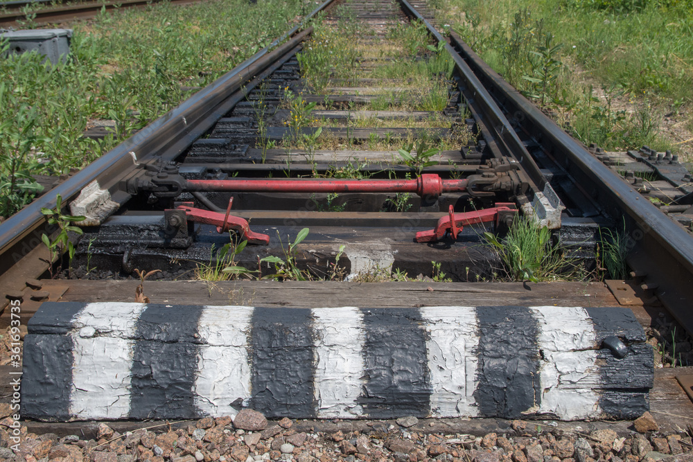 Railway switchboard with electric drive and red rod fixed on resinous ...