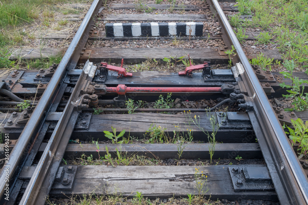 Railway switchboard with electric drive and red rod fixed on resinous ...