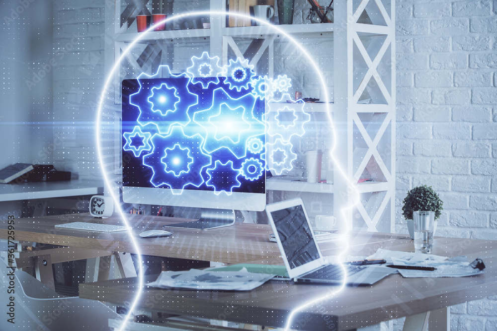 Double exposure of work table with computer and brain sketch hologram ...