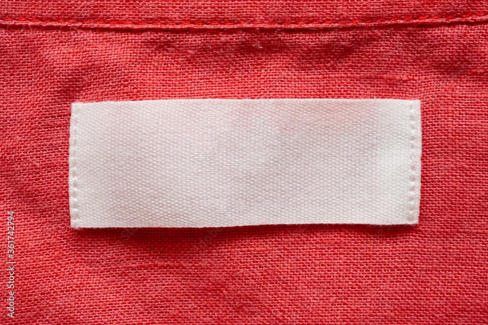Blank clothing tag label on linen shirt fabric texture background Stock ...