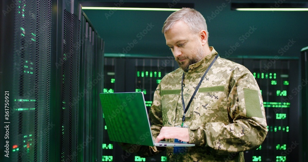 US army senior Caucasian male soldier working at laptop computer in ...