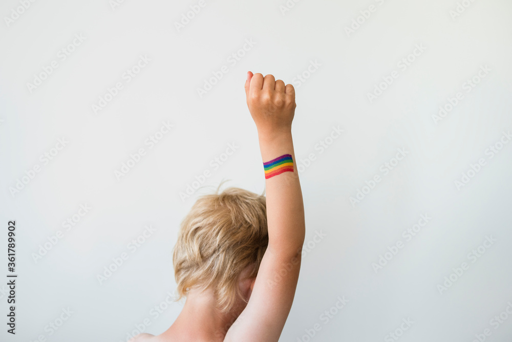 Rised child hand with rainbow LGBTQ pride flag tattoo Stock Photo ...