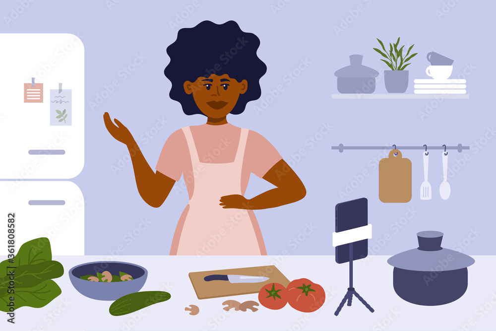 Black woman cooking on kitchen. Female blogger in apron preparing ...