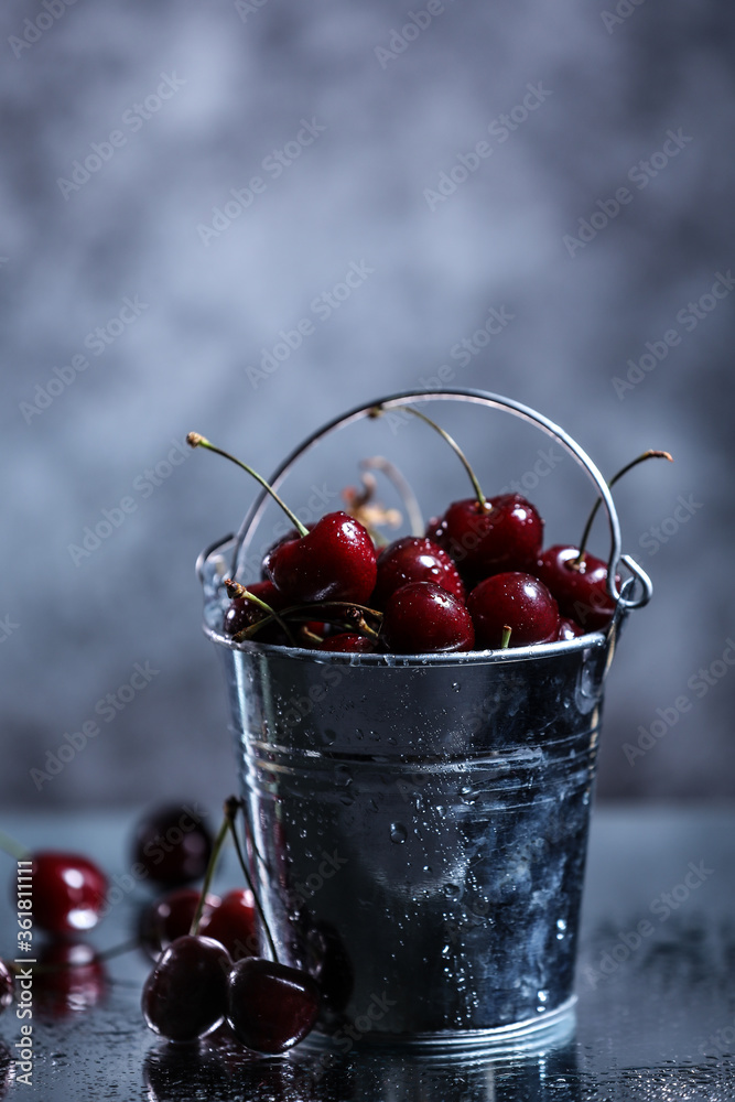 Red sweet cherries in a metal bucket on grey background. Summer taste ...