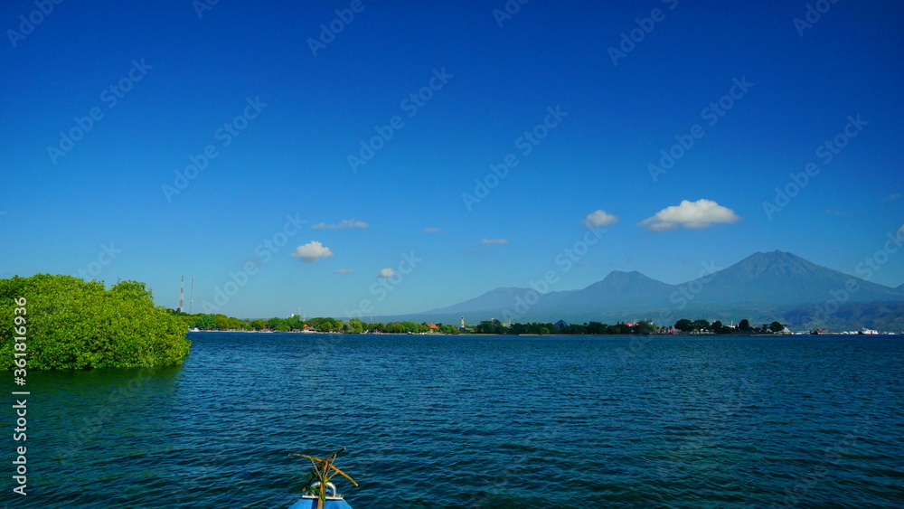A view from Bali strait to Java island. Bali Strait is a stretch of ...