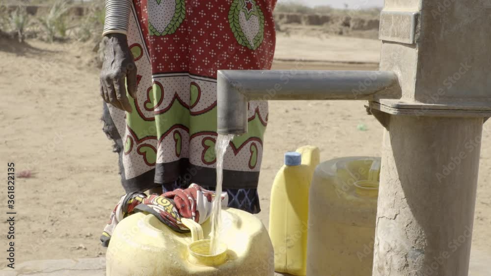 Two women collecting clean water from local borehole. The two women ...
