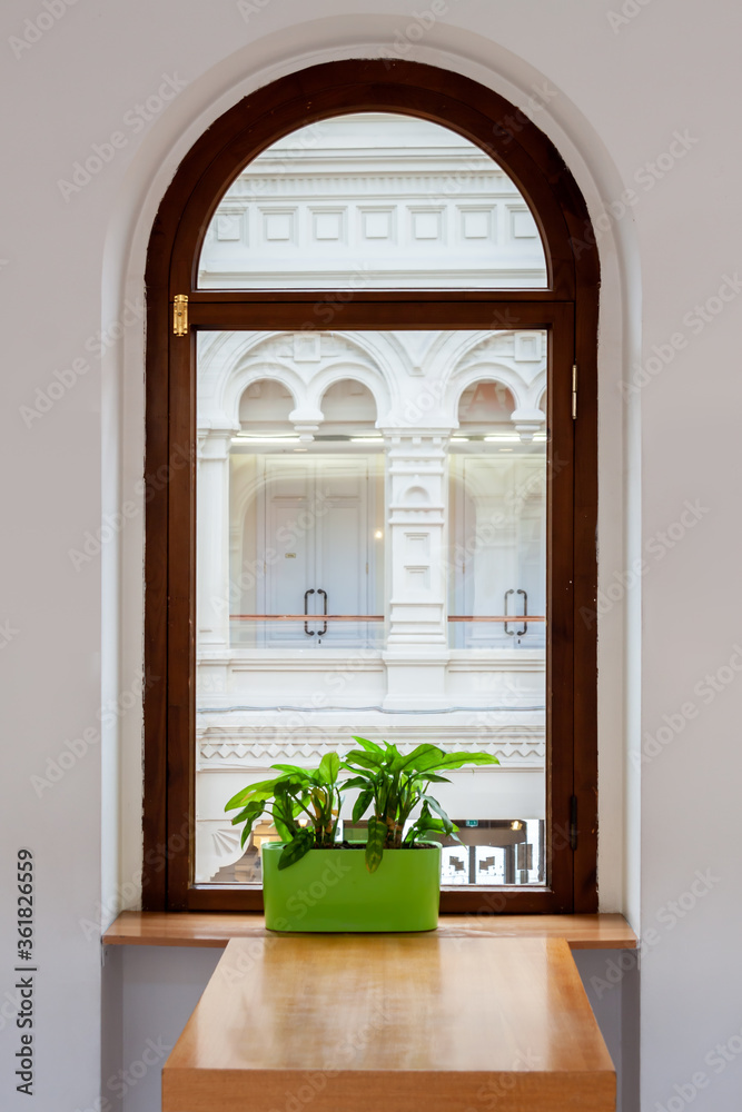 Light pastel dining room with half circle wood window with square table ...