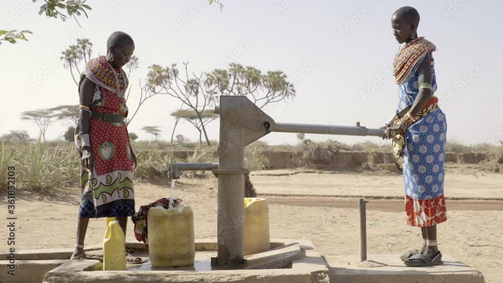 Two women collecting clean water from local borehole. The two women ...
