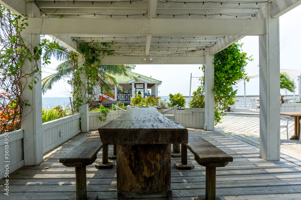 long rustic wood table under a covered gazebo Stock Photo | Adobe Stock