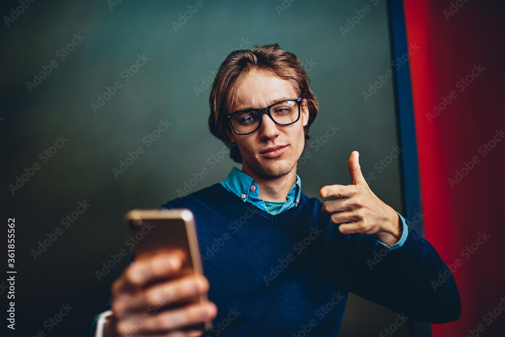 Young caucasian male showing ok sign during online conversation with ...
