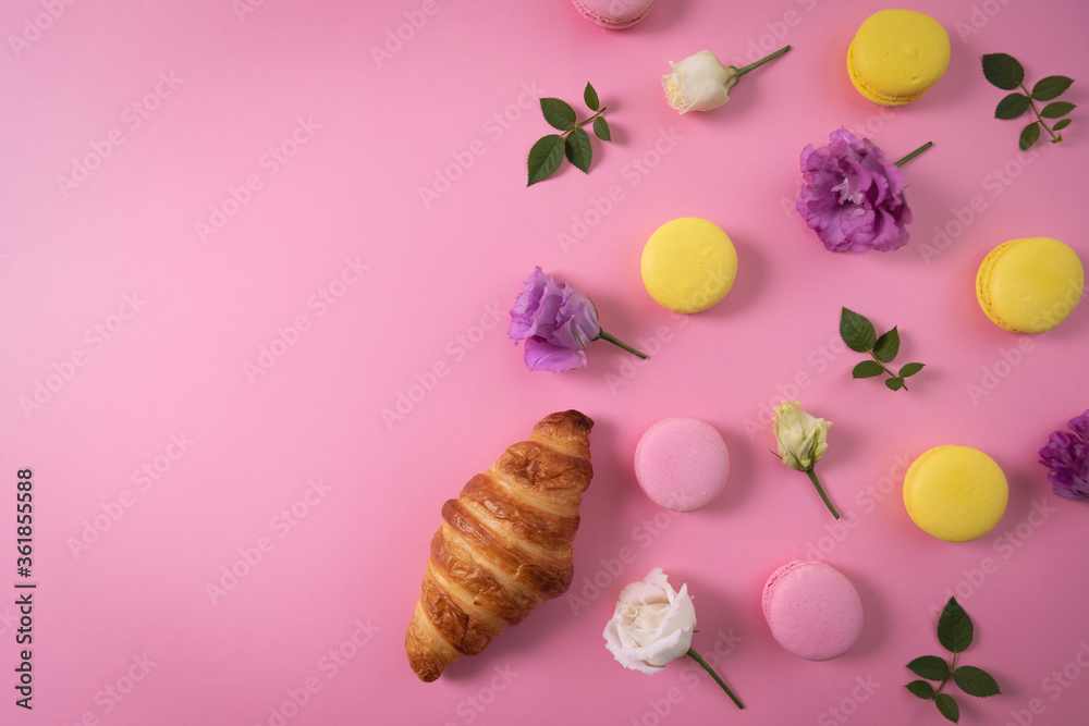 french pastry - macarons and croissant with flowers on pink background ...
