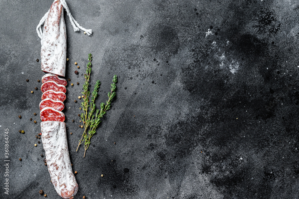 Spanish dry salami sausage Fuet. Black background. Top view. Space for ...