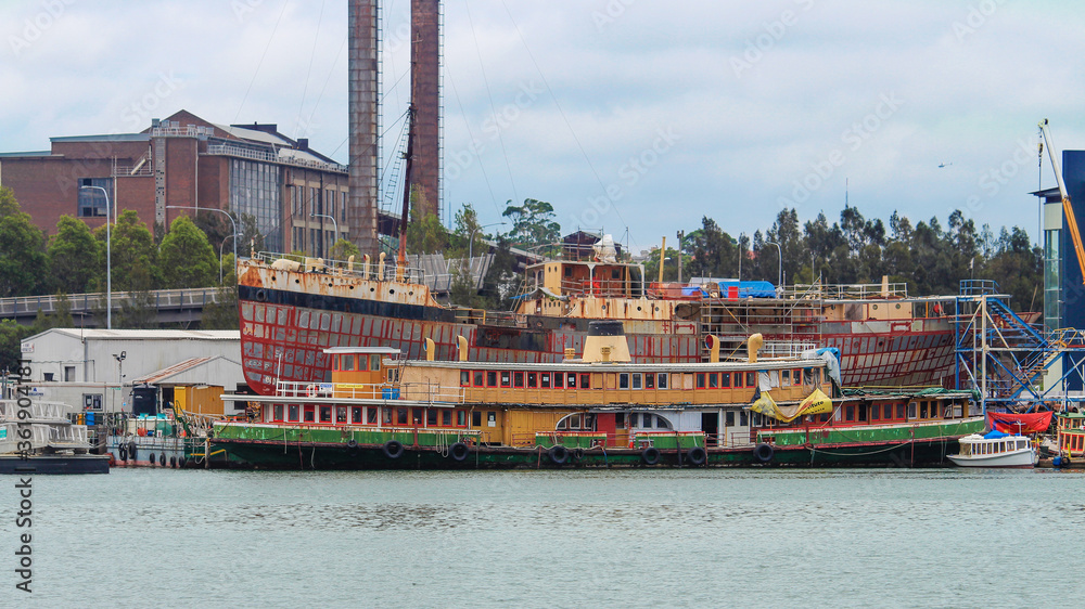 Ship yard in a bay with old ferry and the restoration of the John Oxley ...