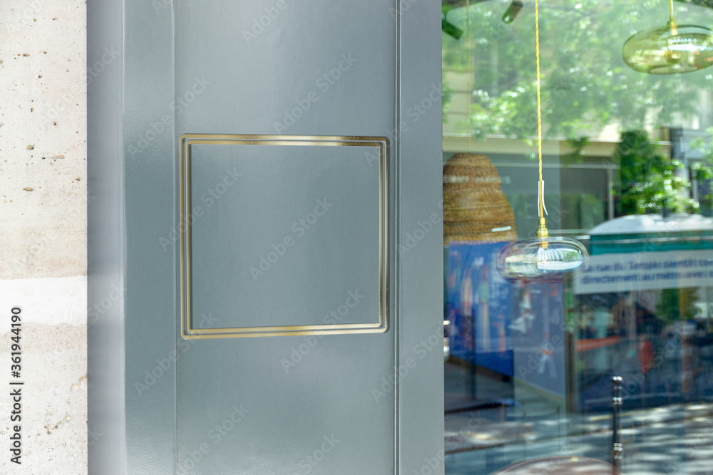 Storefront plate on a grey shop door Mockup. Empty store brand ...