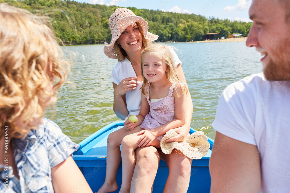 Family takes a boat trip on the lake Stock Photo | Adobe Stock