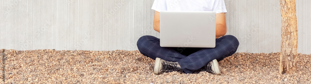 haft body of man meditating in a rock garden sitting beside a dry tree ...