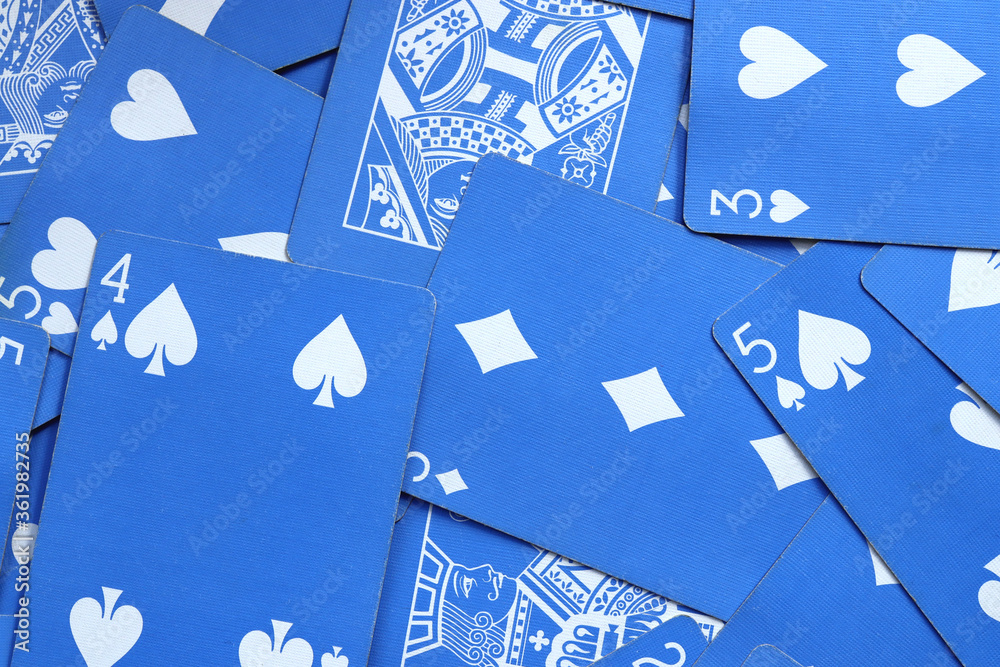 Assorted play cards backdrop. Many miscellaneous jumbled blue playing ...