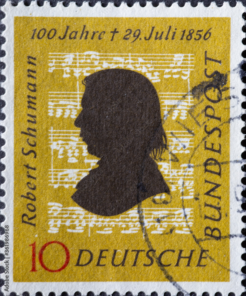 composer Robert Schumann against the background of musical notes. the ...