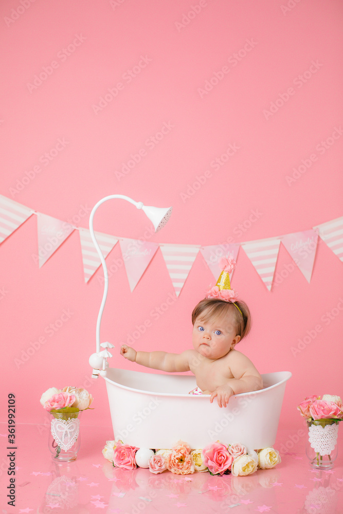 Smash cake party. Little cheerful birthday girl with first cake. Happy ...