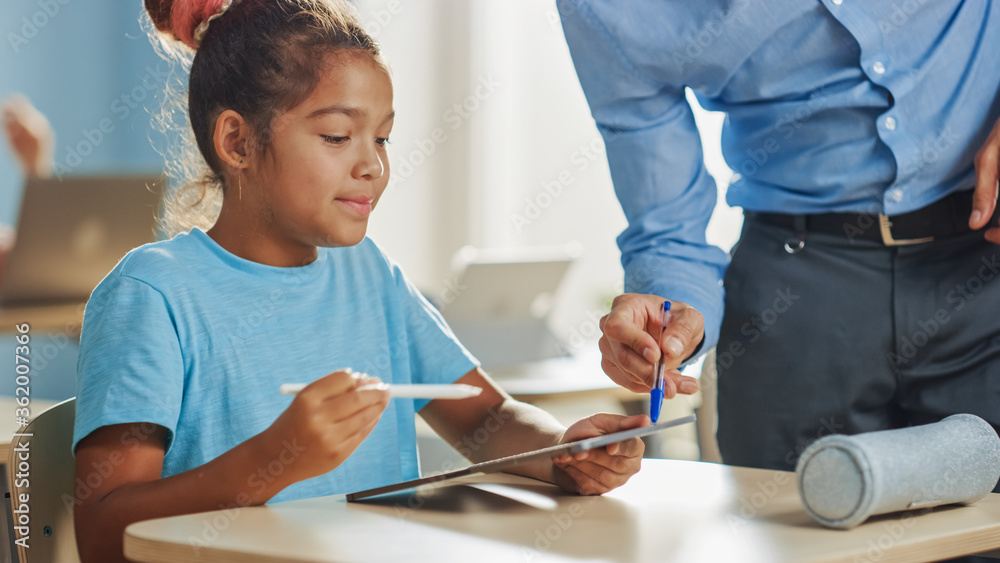 Foto de Elementary School Computer Science Class: Smart Girl Uses ...