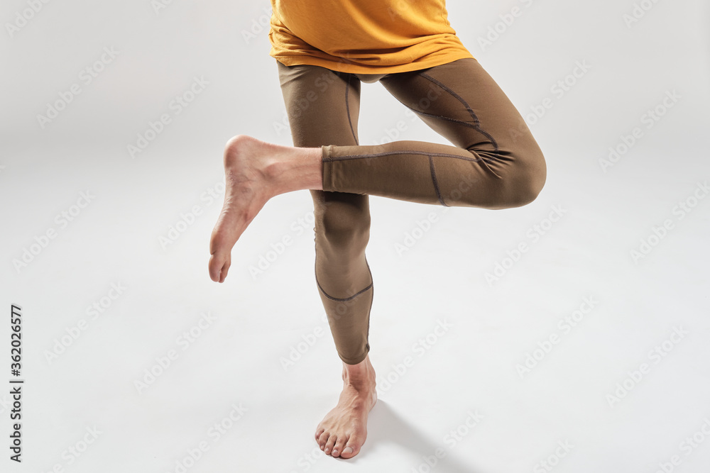 Crossed legs of a young man balancing over one leg Stock Photo | Adobe ...