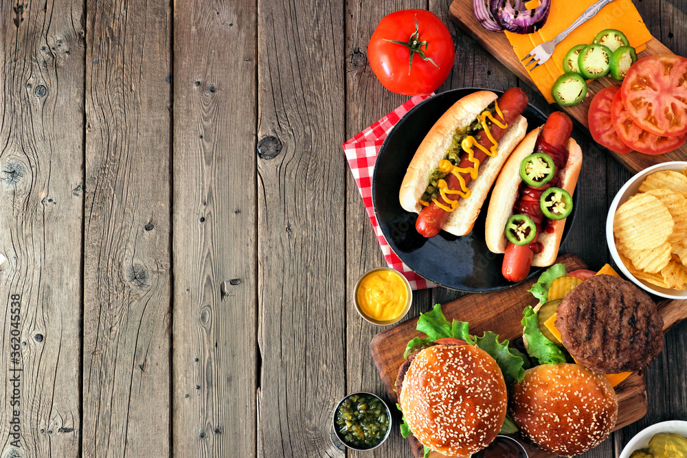 Summer BBQ food side border with hot dog and hamburger buffet. Overhead ...