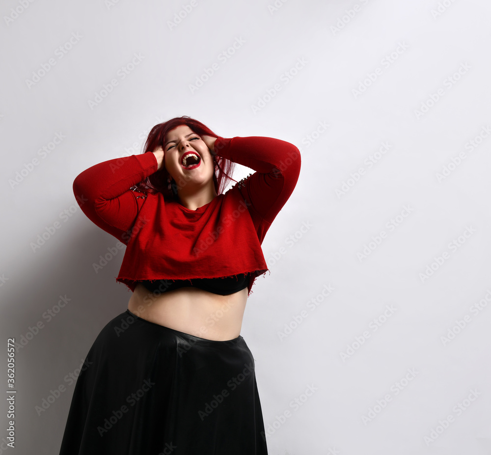 Fat redhead lady in a red studded top, black leather skirt and earrings ...