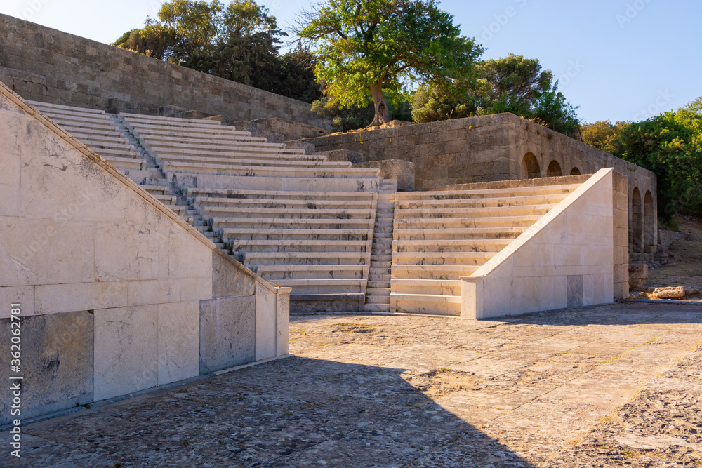 Ancient theater with marble seats and stairs. The Acropolis of Rhodes ...
