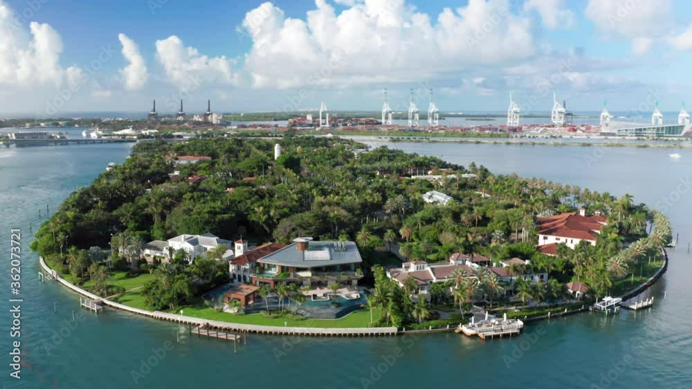 Clear green water surrounds lavish nature of tropical island. 4K aerial ...