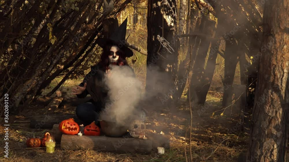 Sorceress performs a magic ritual in the autumn forest. Theme of the ...