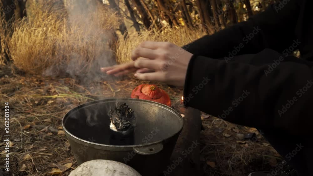 Video Stock Hands of a witch witchcraft over a cauldron close up. Theme ...