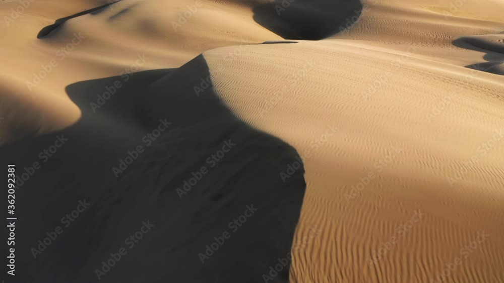 Aerial of the desert nature at sunset. Flying on a plane over the sand ...