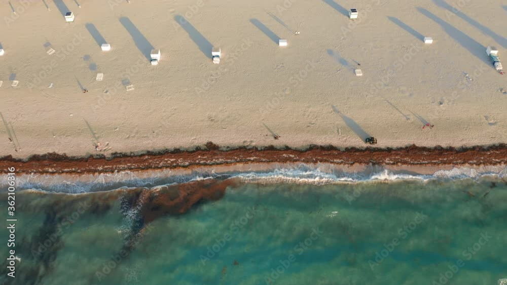 Morning light is illuminating the empty tropical white sand beach ...