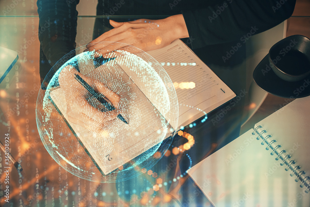 Double exposure of hands making notes with world map hologram and data ...